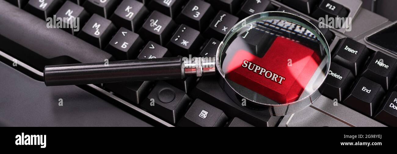 Black keyboard from a computer with a magnifying glass. Enter and ...