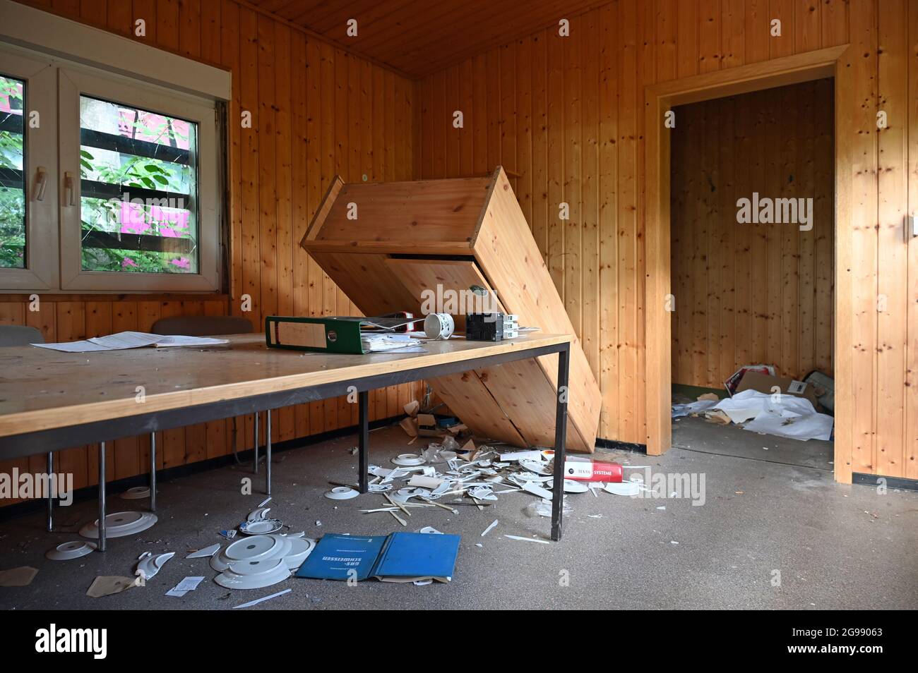 Devastated office with a thrown filing cabinet Stock Photo - Alamy