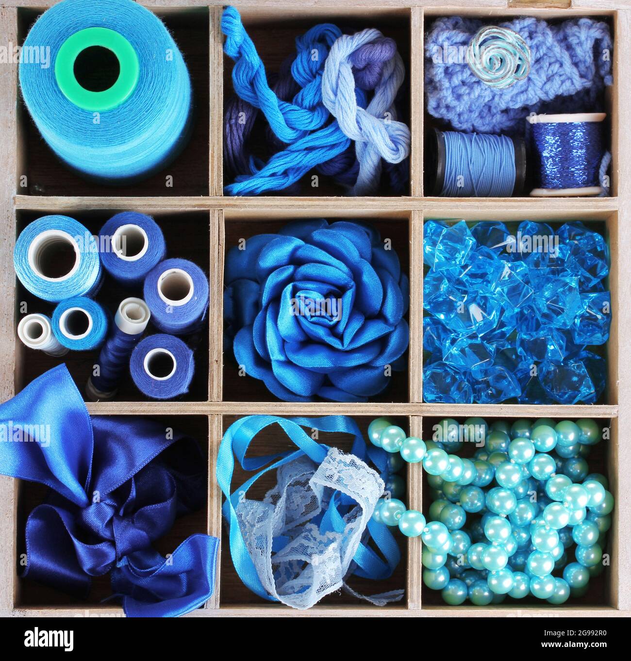 Blue thread and material for handicrafts in box isolated on white Stock ...