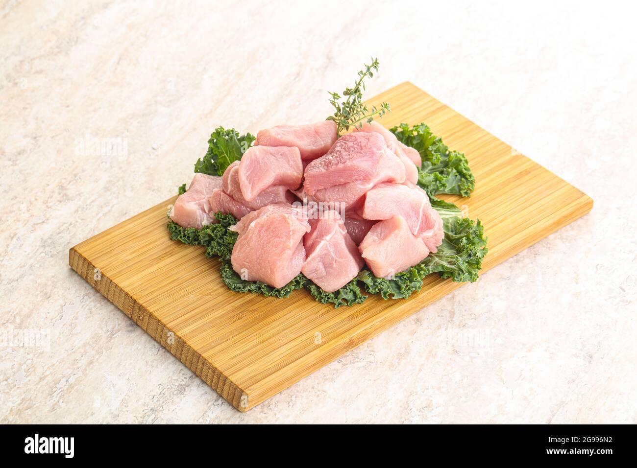 Raw pork meat cubes for coocking over board Stock Photo - Alamy