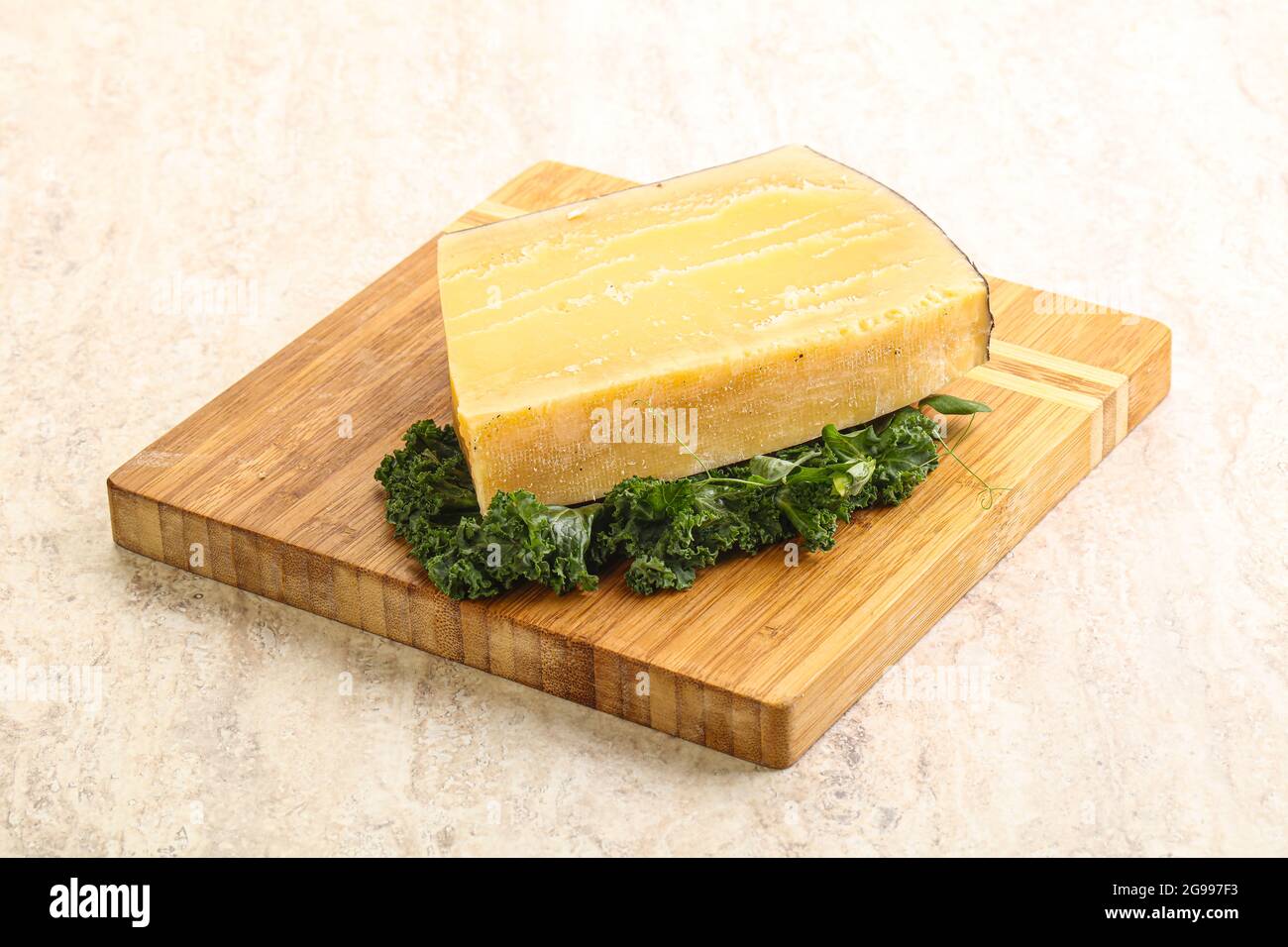 Hard Parmesan cheese piece over board Stock Photo - Alamy
