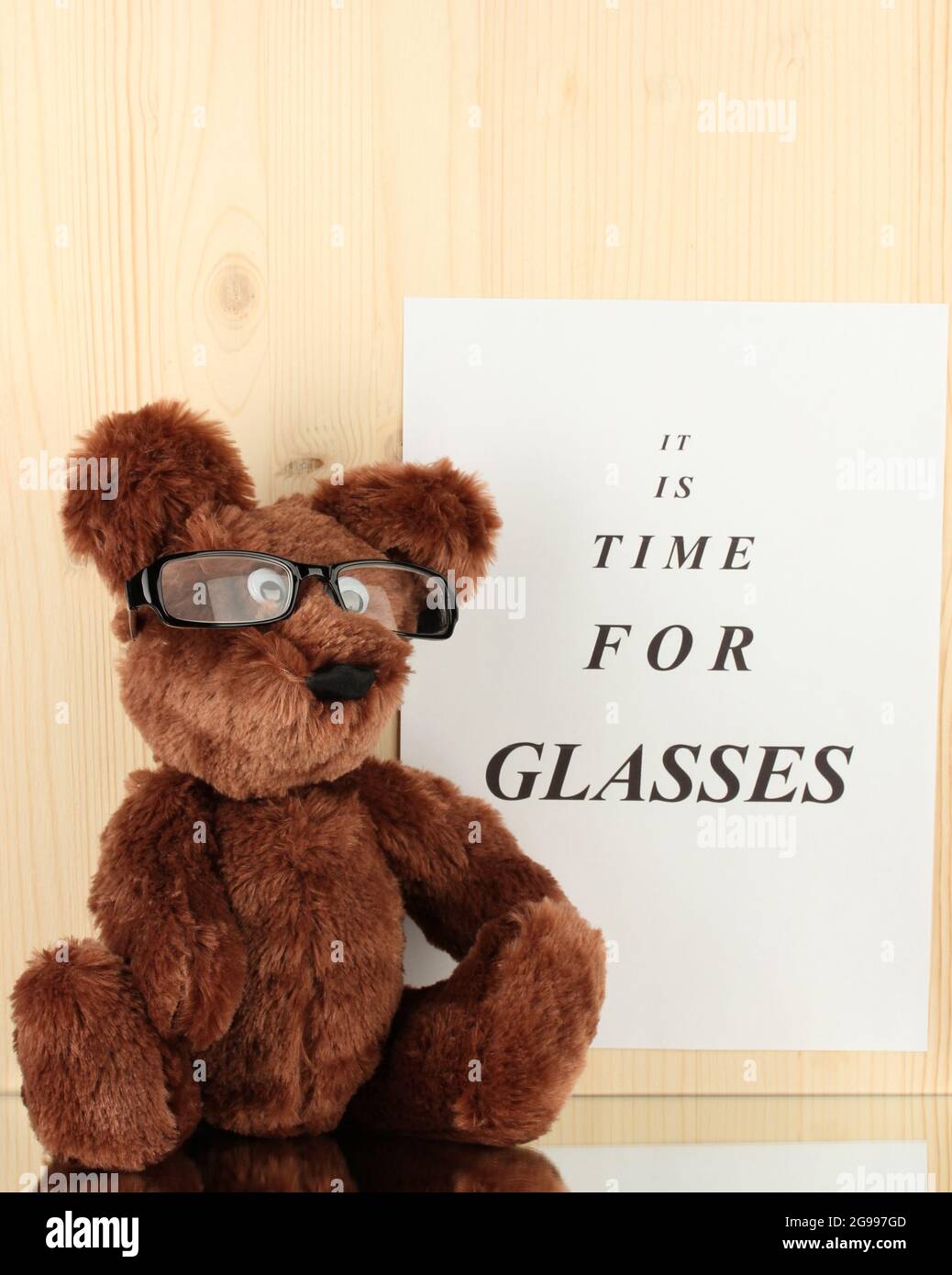 Eyesight test chart with glasses and with toy on wooden background ...