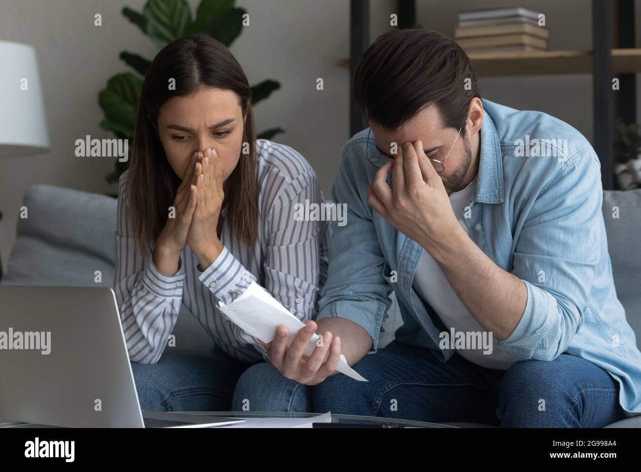 Stressed young couple calculating expenses feel upset Stock Photo - Alamy