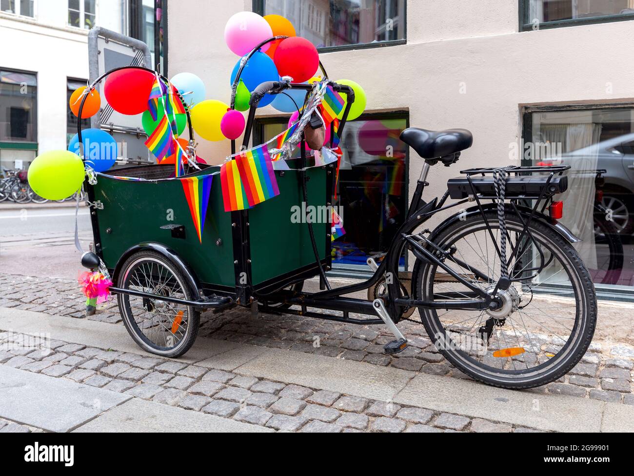 Bicycle with a cart decorated with colorful flags and balloons ...