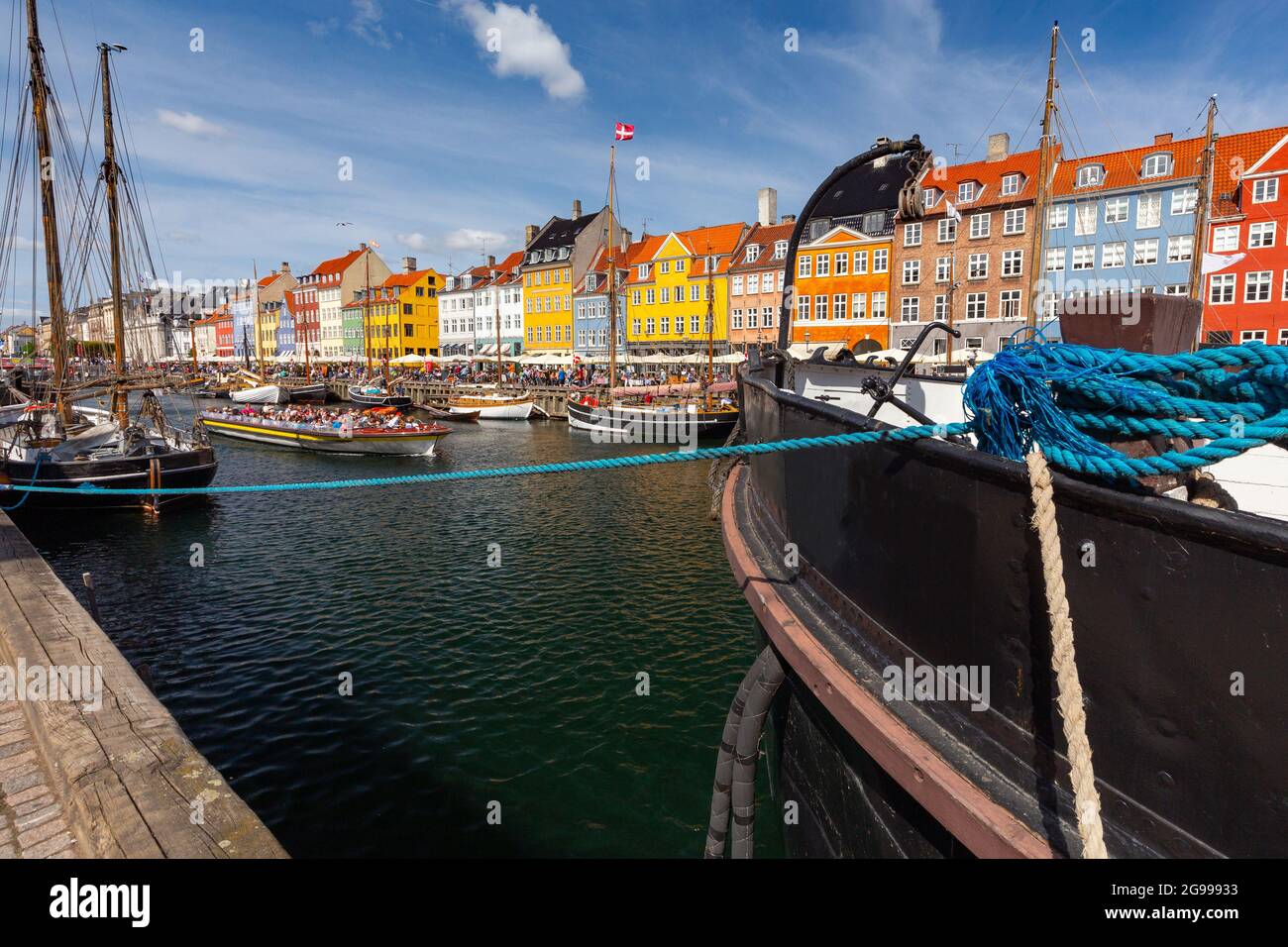 Multicolored facades of old medieval houses and ships along the canal ...