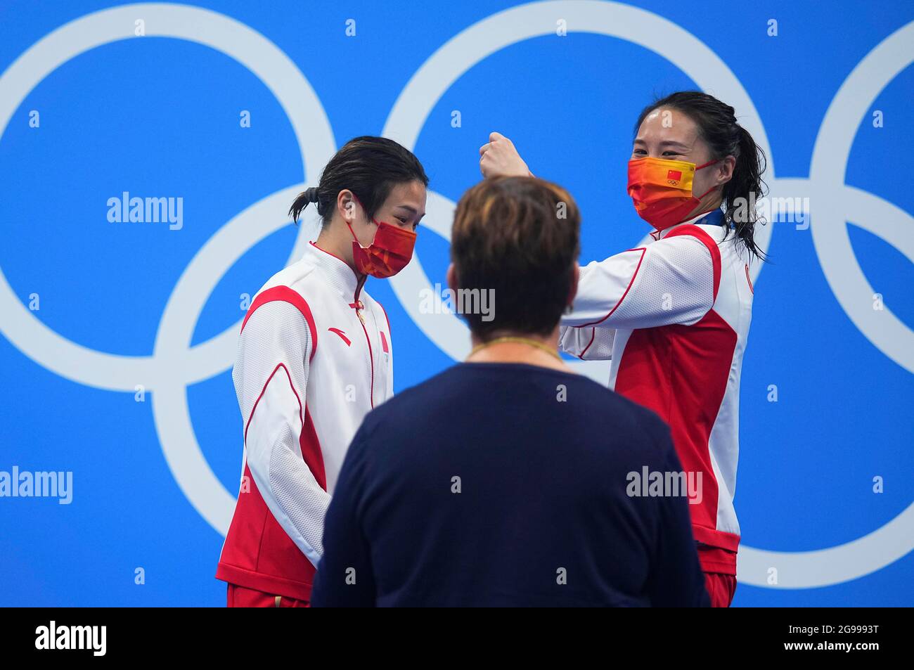 Tokyo, Japan. 25th July, 2021. Wang Han (R) of China helps her partner ...