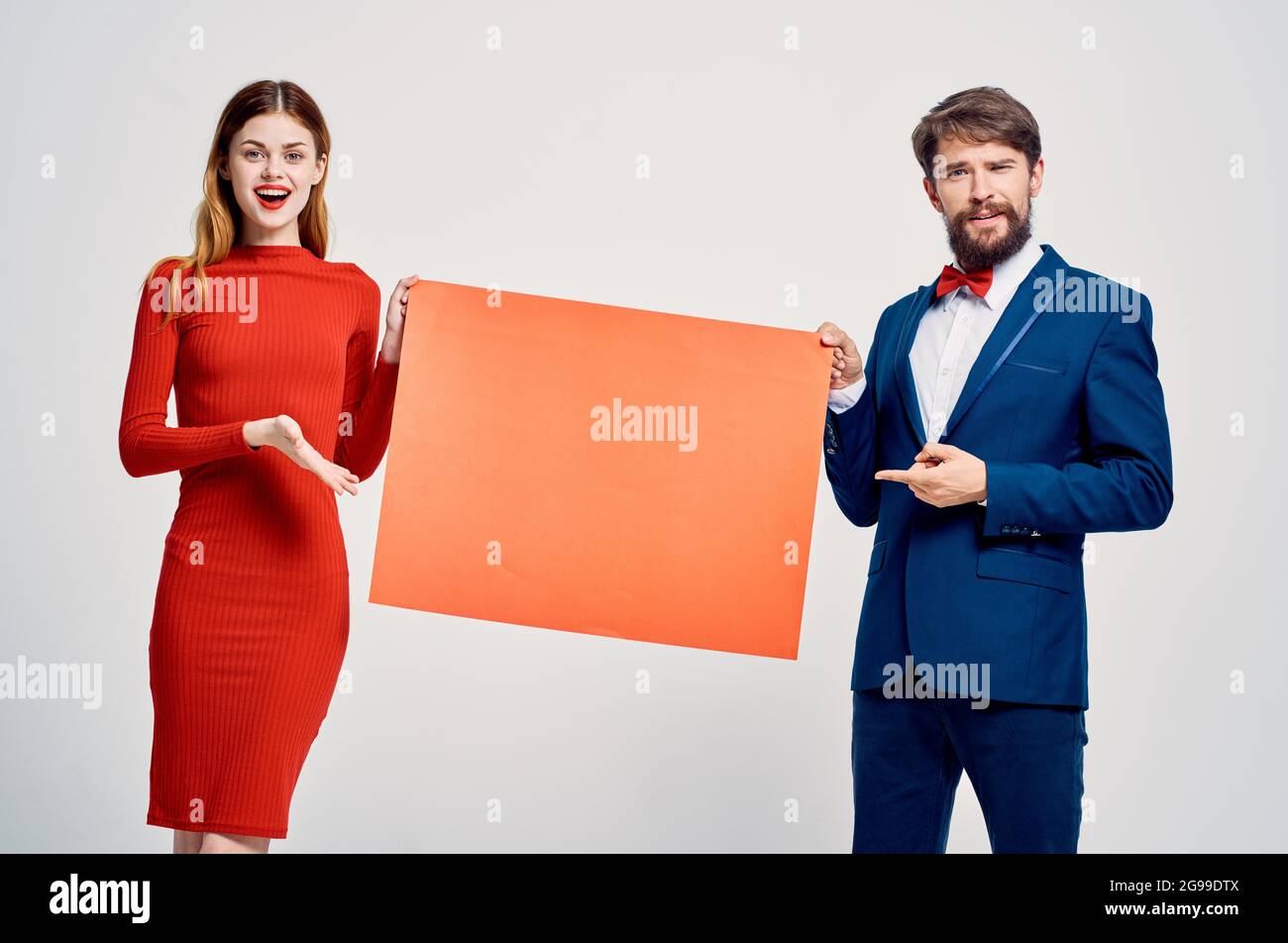 national man and woman holding on to mocap poster advertising Stock ...