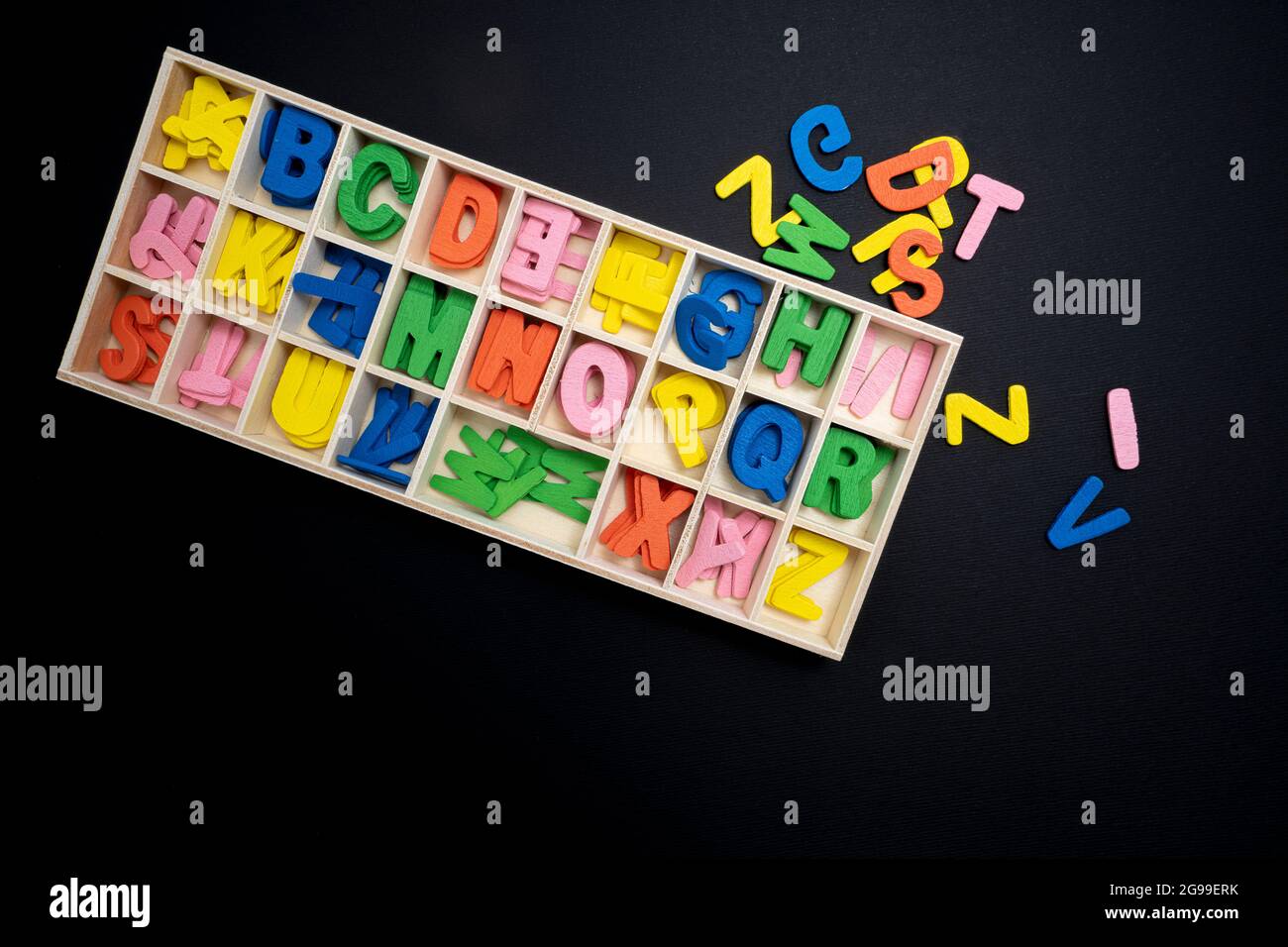 some colorful letters in a wooden box Stock Photo - Alamy