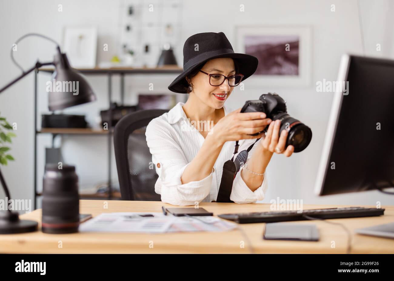 Photographer viewing pictures at office Stock Photo - Alamy