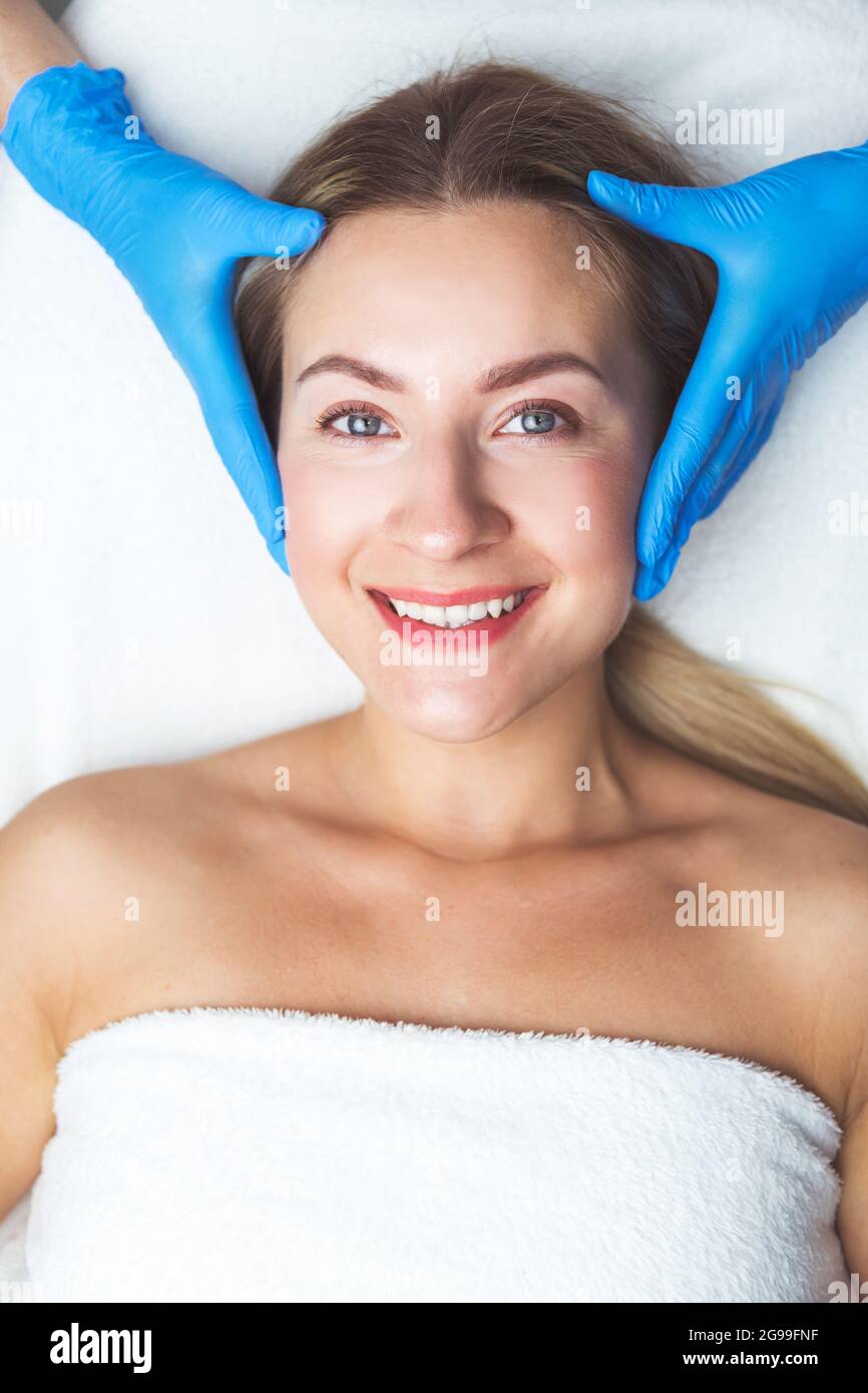 Happy woman after facial massage, young and fresh female in spa, beauty ...