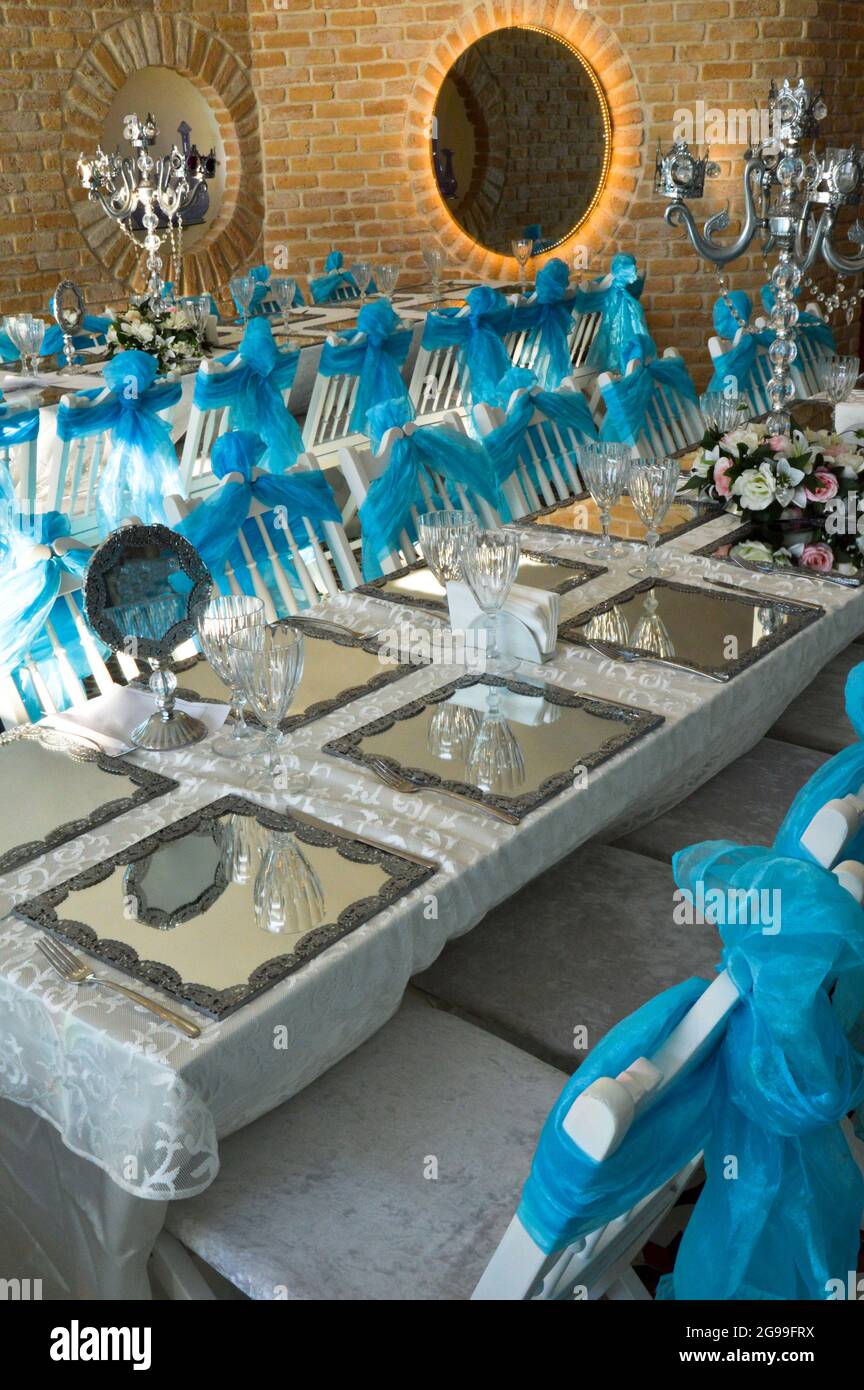 Ornate empty dining tables in a modern restaurant ready to serve, a ...