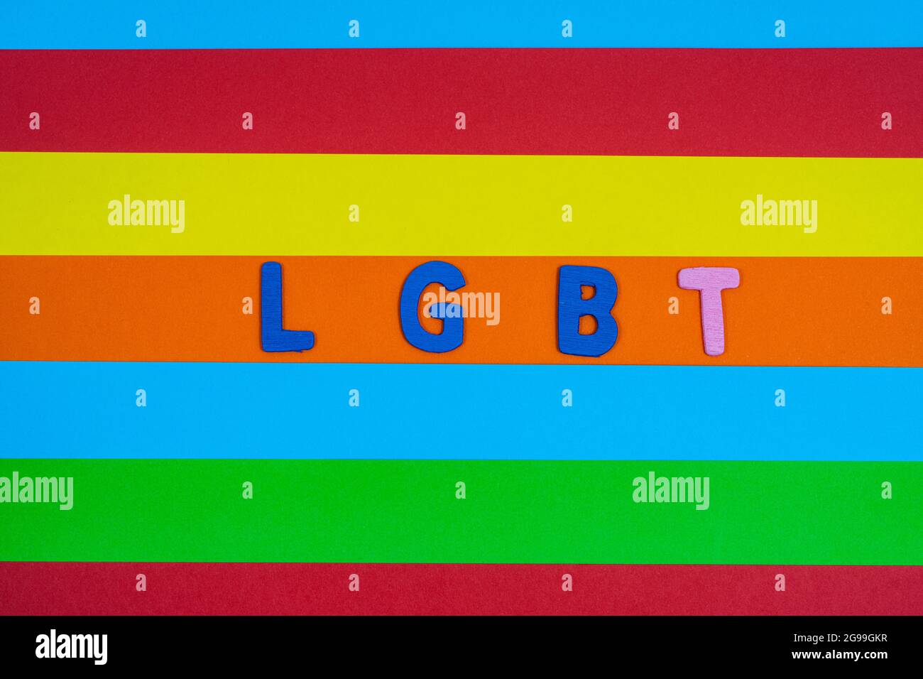 the word LGBT on a surface with some colored stripes to form a rainbow ...