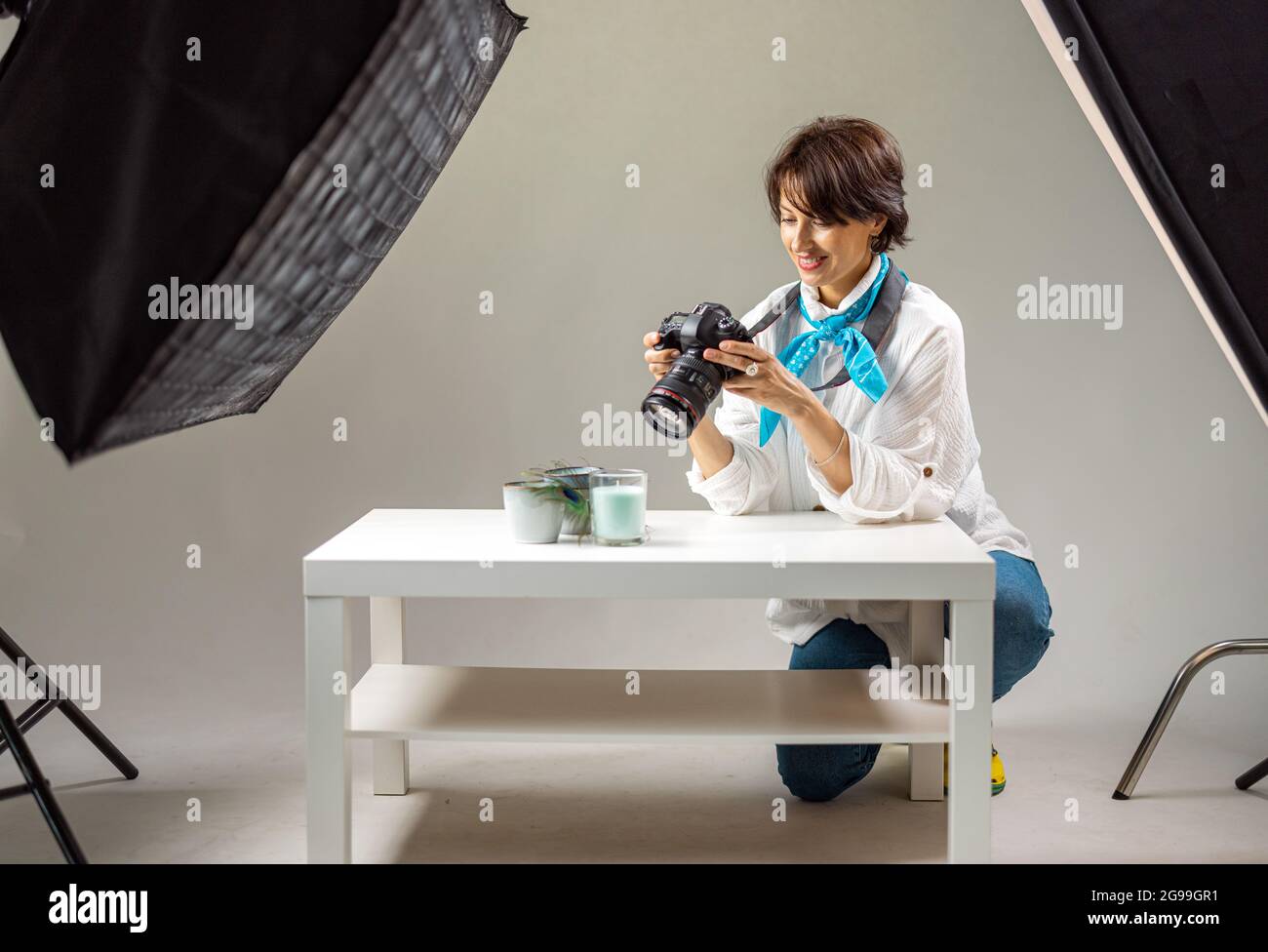 Photographer with camera in studio Stock Photo - Alamy