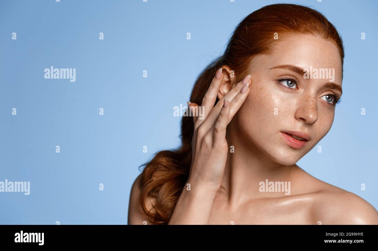 Women wellbeing. Attractive redhead girl with freckles, touching smooth ...