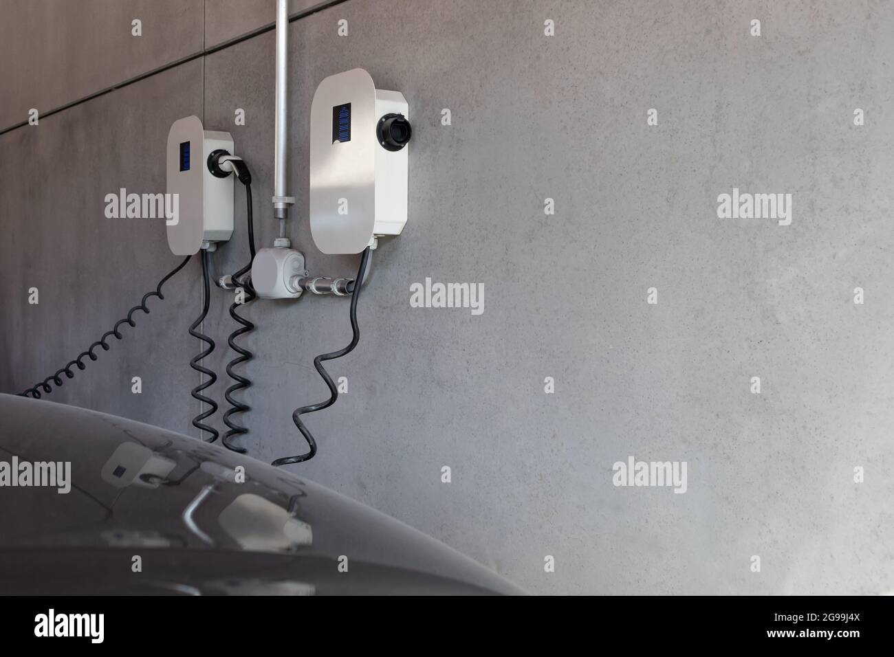 electric charger on a concrete wall Stock Photo - Alamy