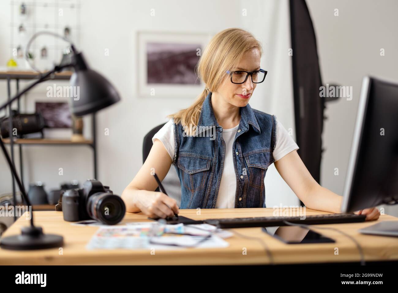 Photographer editing taken pictures Stock Photo - Alamy