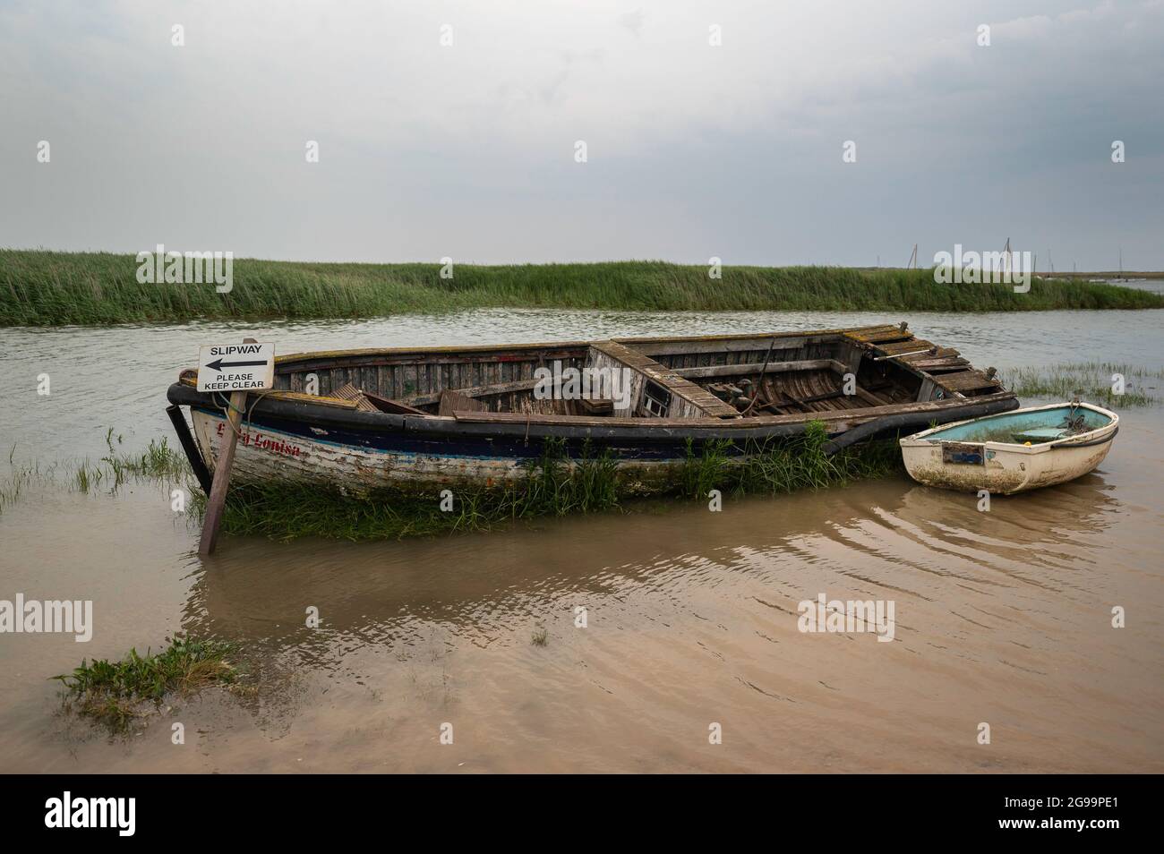 Brancaster Staithe boat wreck laying in sea water at high tide Stock ...