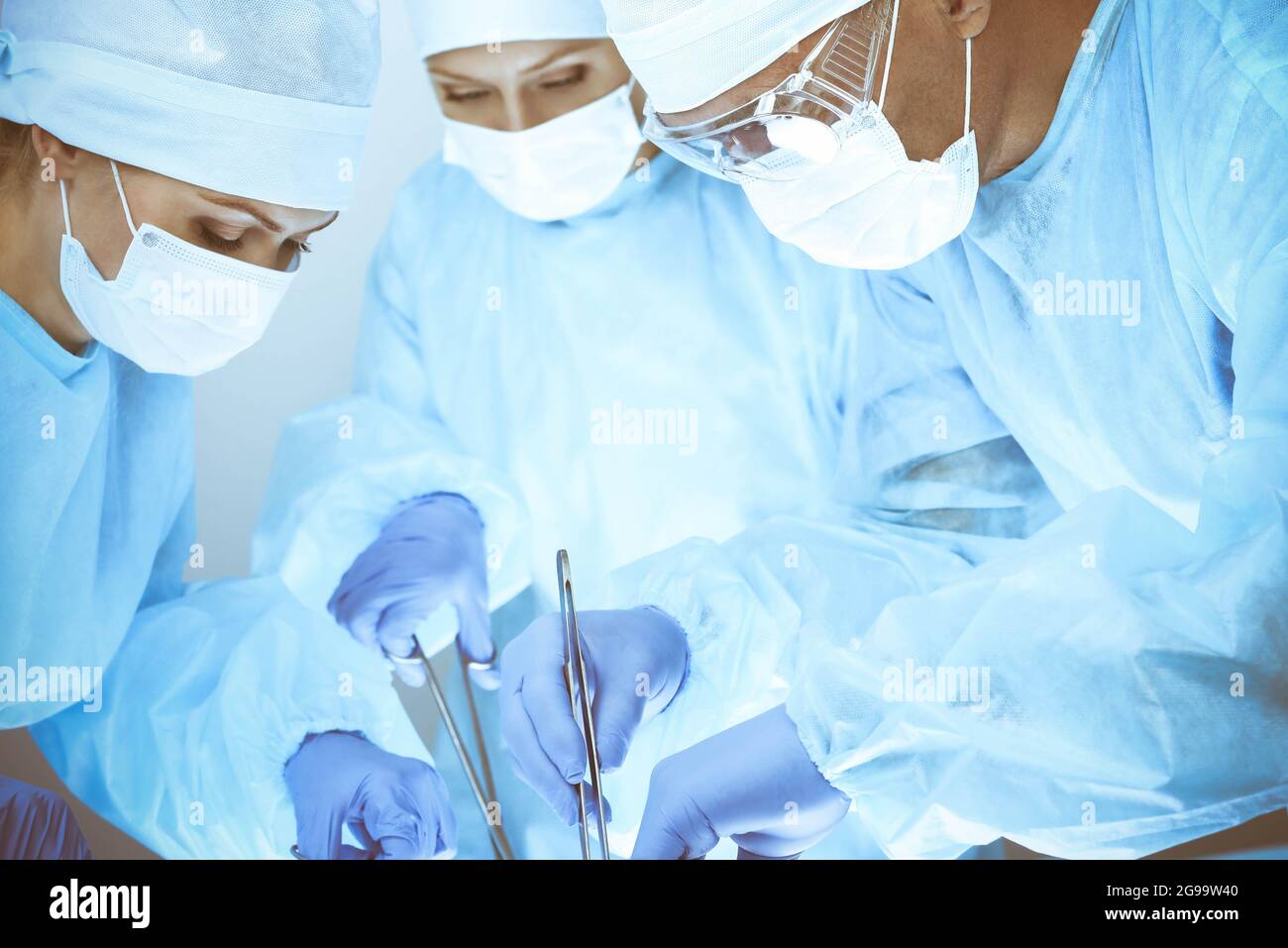 A group of surgeons is operating at the hospital. Health care concept ...