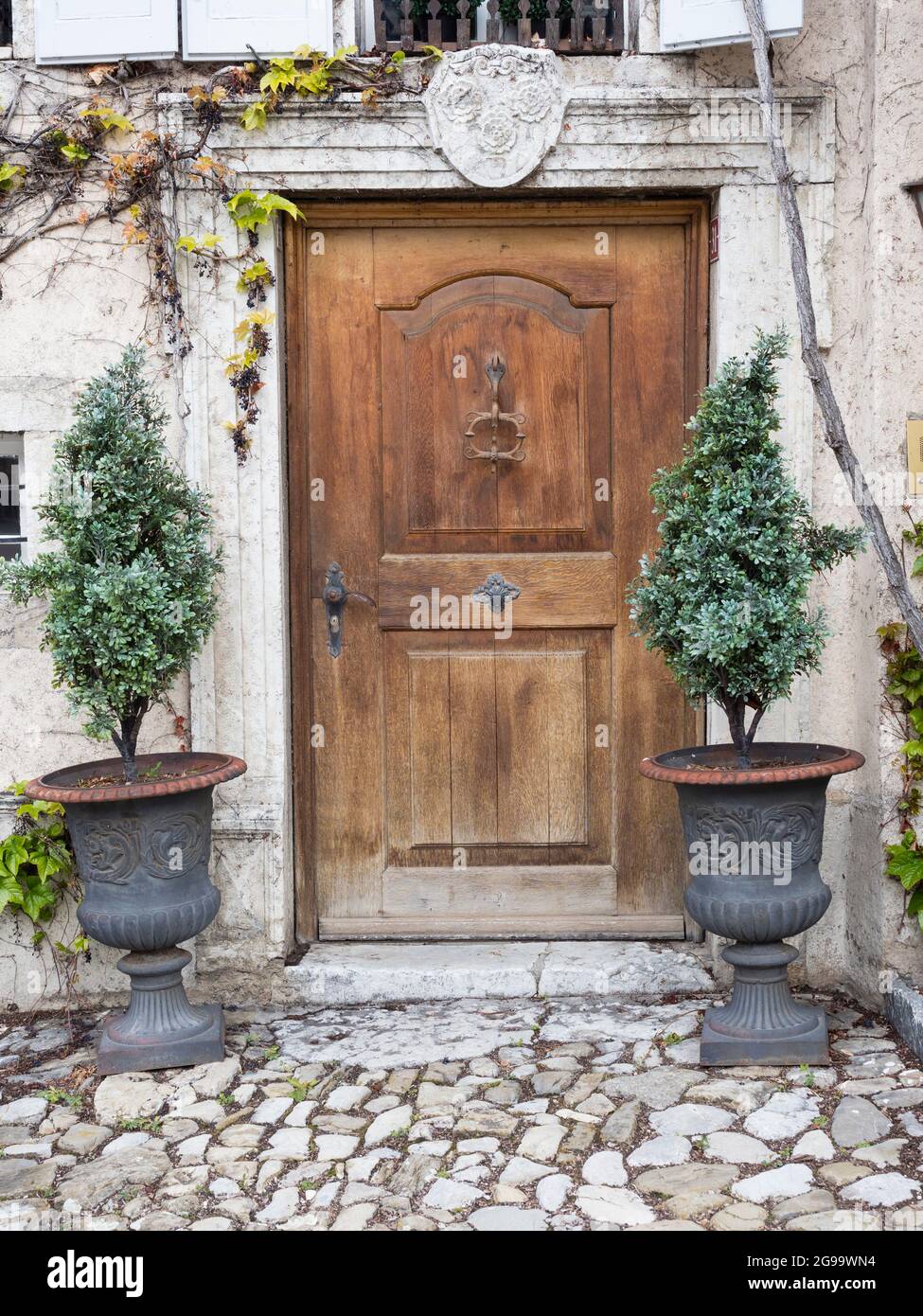 Ornamented wooden door and facade of a traditional Swiss building in ...
