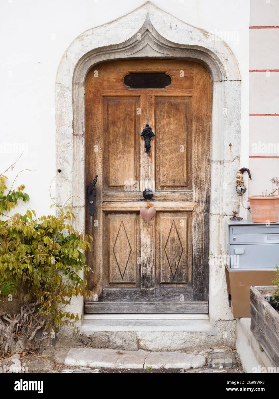 Ornamented wooden door and facade of a traditional Swiss building in ...