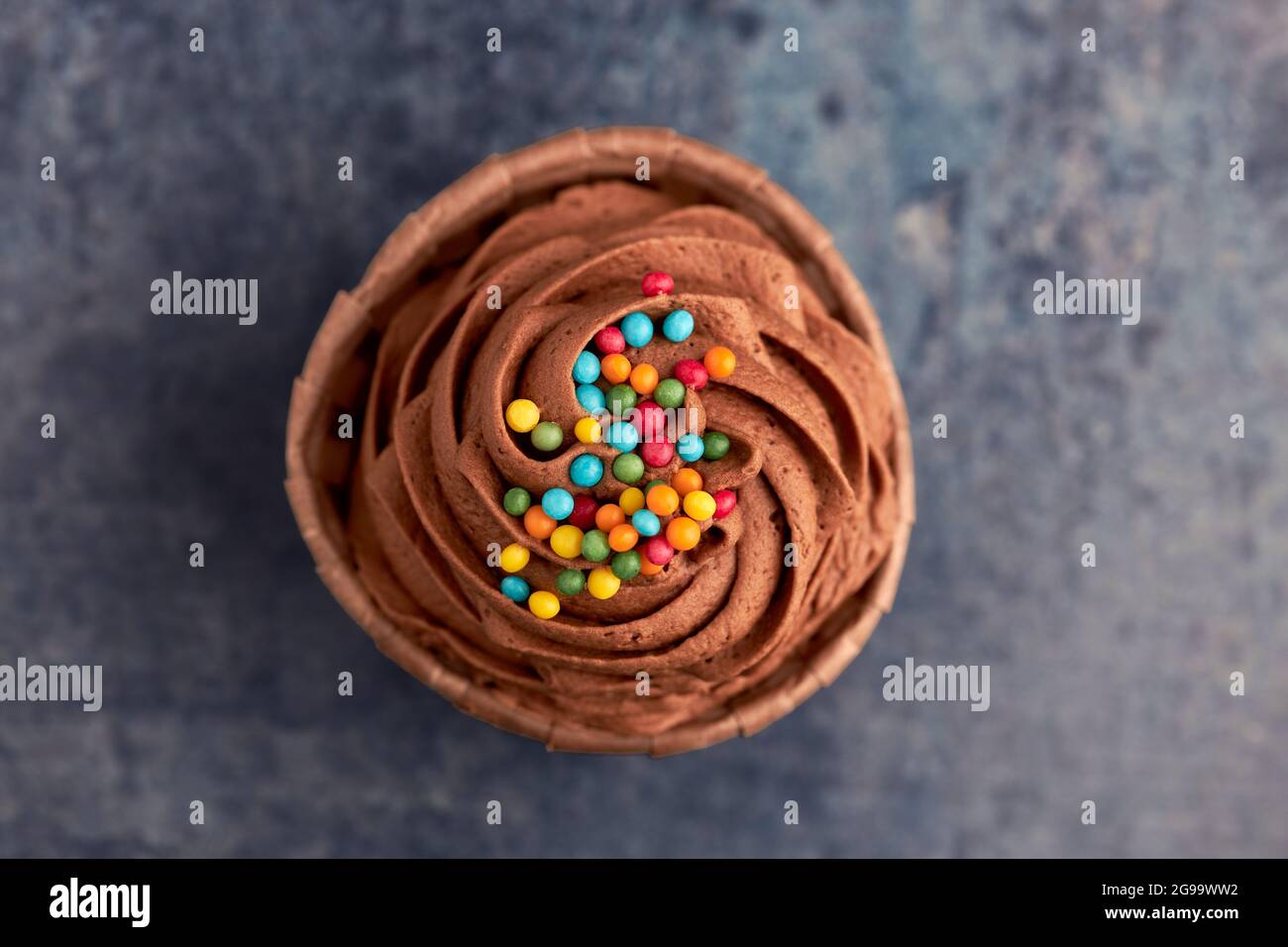 Aerial view of a chocolate cupcake with colored candies Stock Photo - Alamy