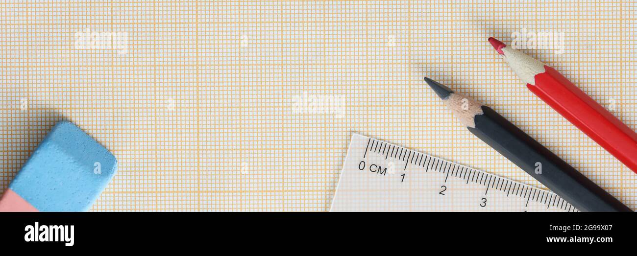Graph paper with pencils and ruler lie on table Stock Photo - Alamy
