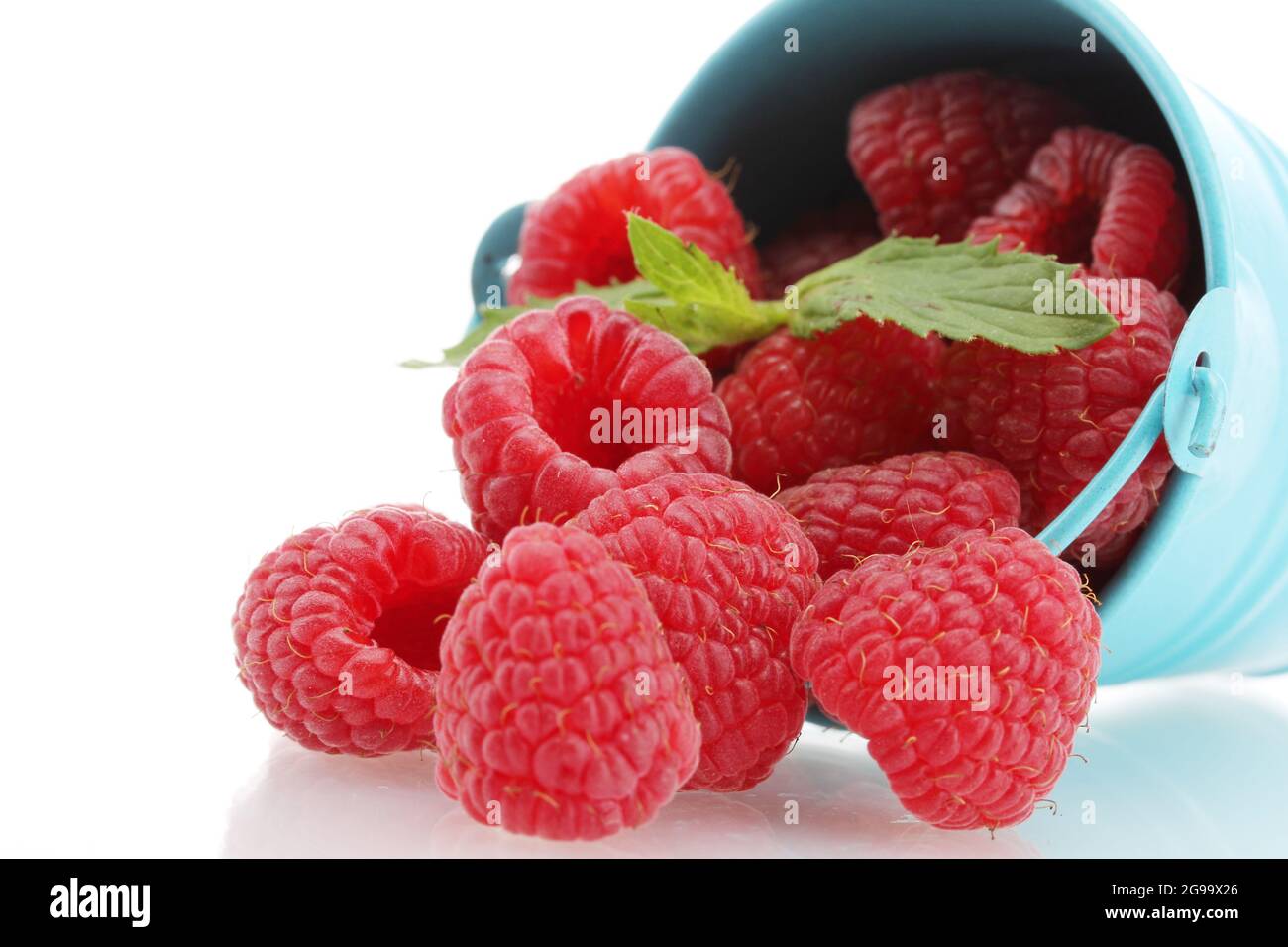 beautiful raspberries in bucket isolated on white Stock Photo - Alamy