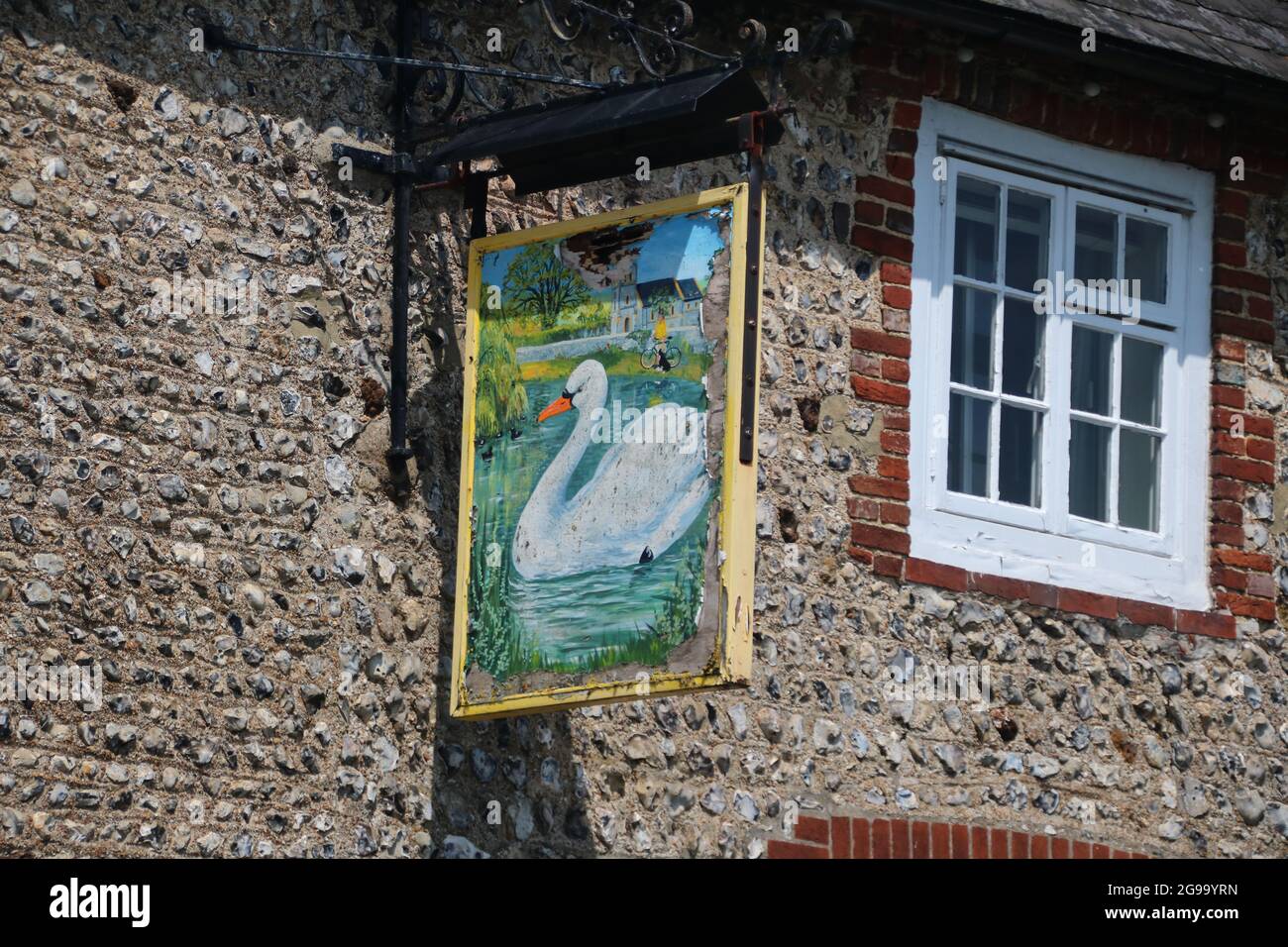 Village pub with Swan Inn sign Stock Photo - Alamy