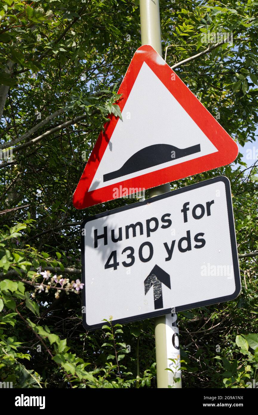 Triangular speed bump warning sign Humps for 430 yds UK Stock Photo - Alamy