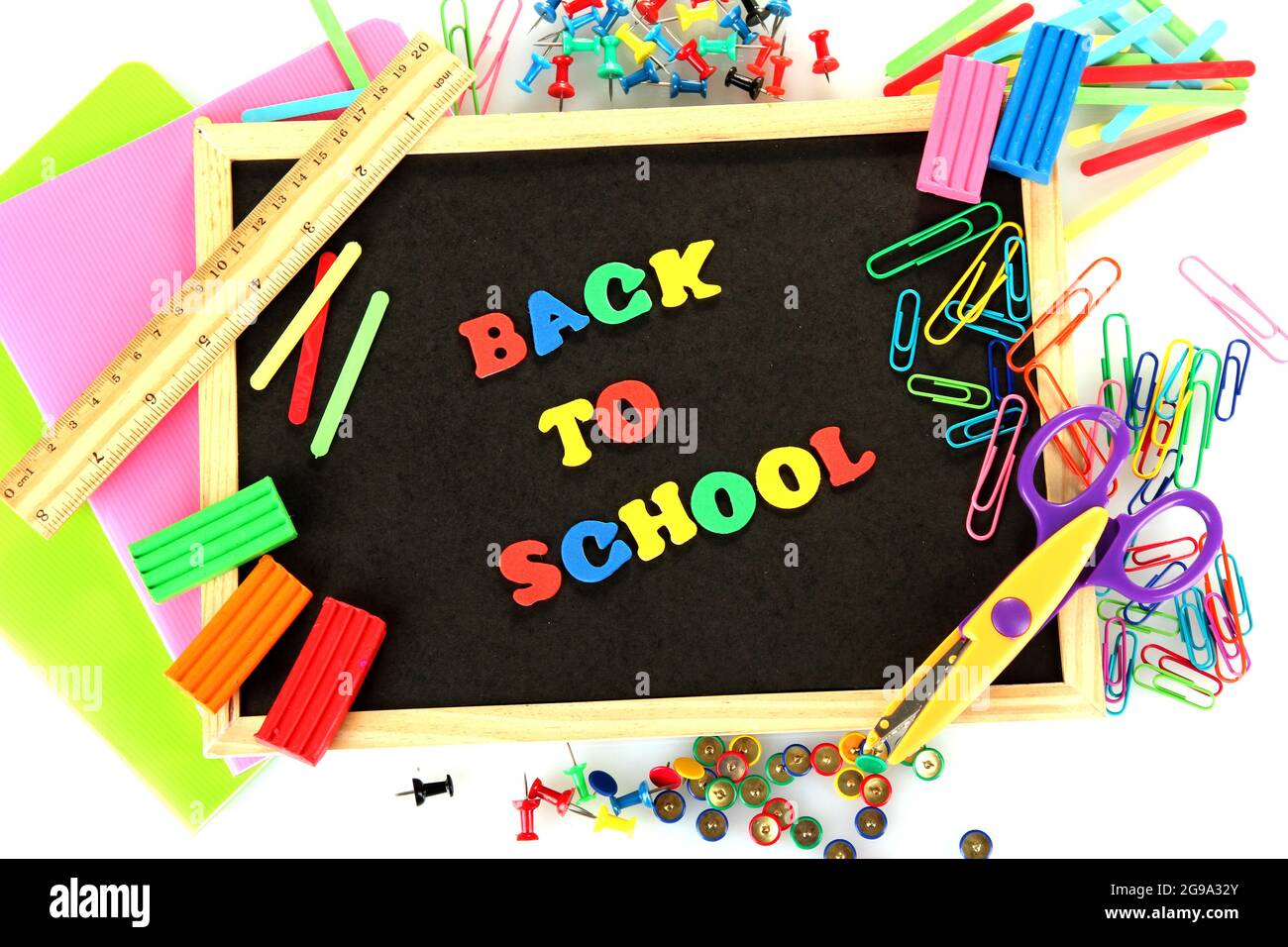 Small chalkboard with school supplies on white background. Back to ...