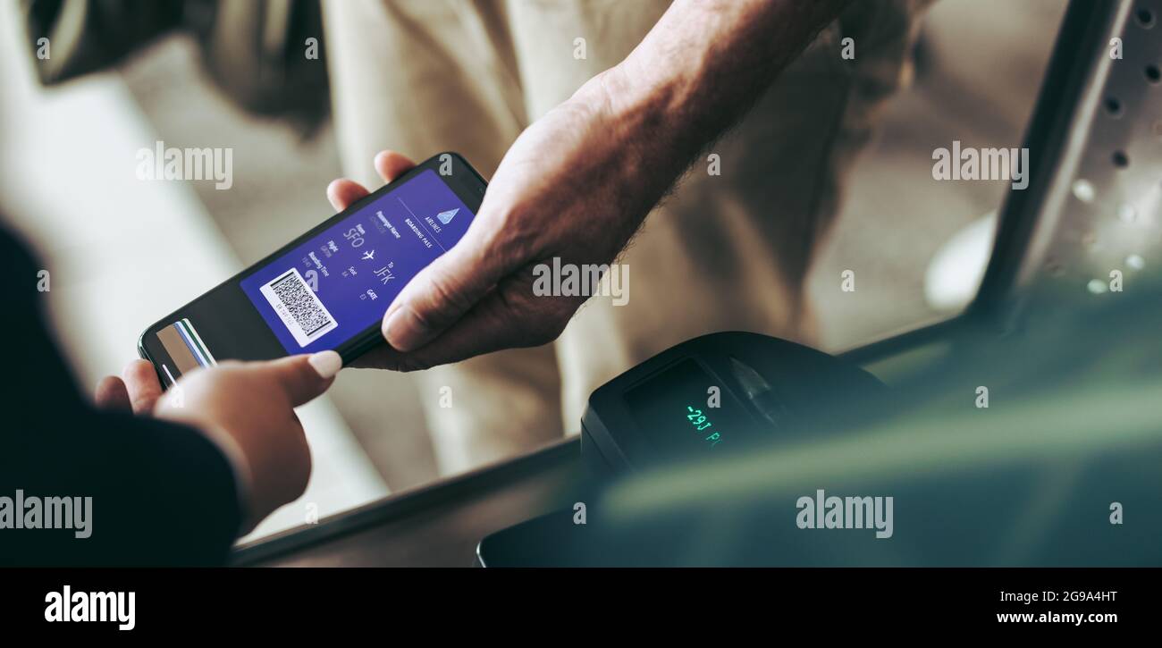 traveler showing boarding pass on mobile phone to flight attendant ...
