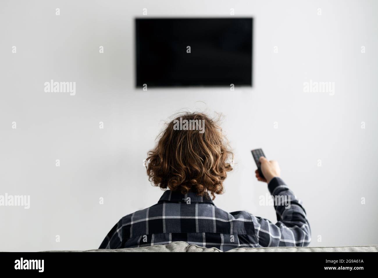 Back View Of Man Watching Television At Home Stock Photo - Alamy