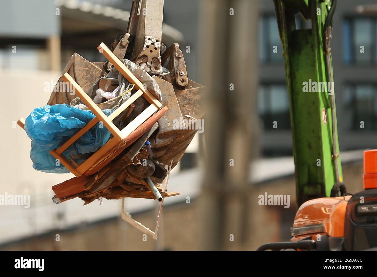 Euskirchen, Germany. 25th July, 2021. An excavator loads bulky waste ...