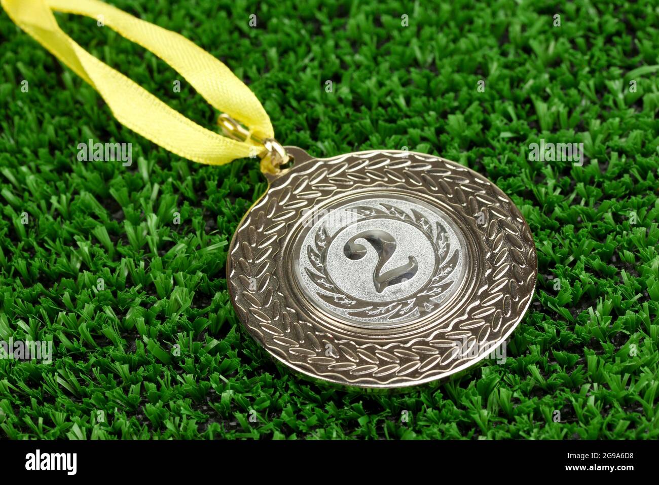 Silver medal on grass background Stock Photo - Alamy