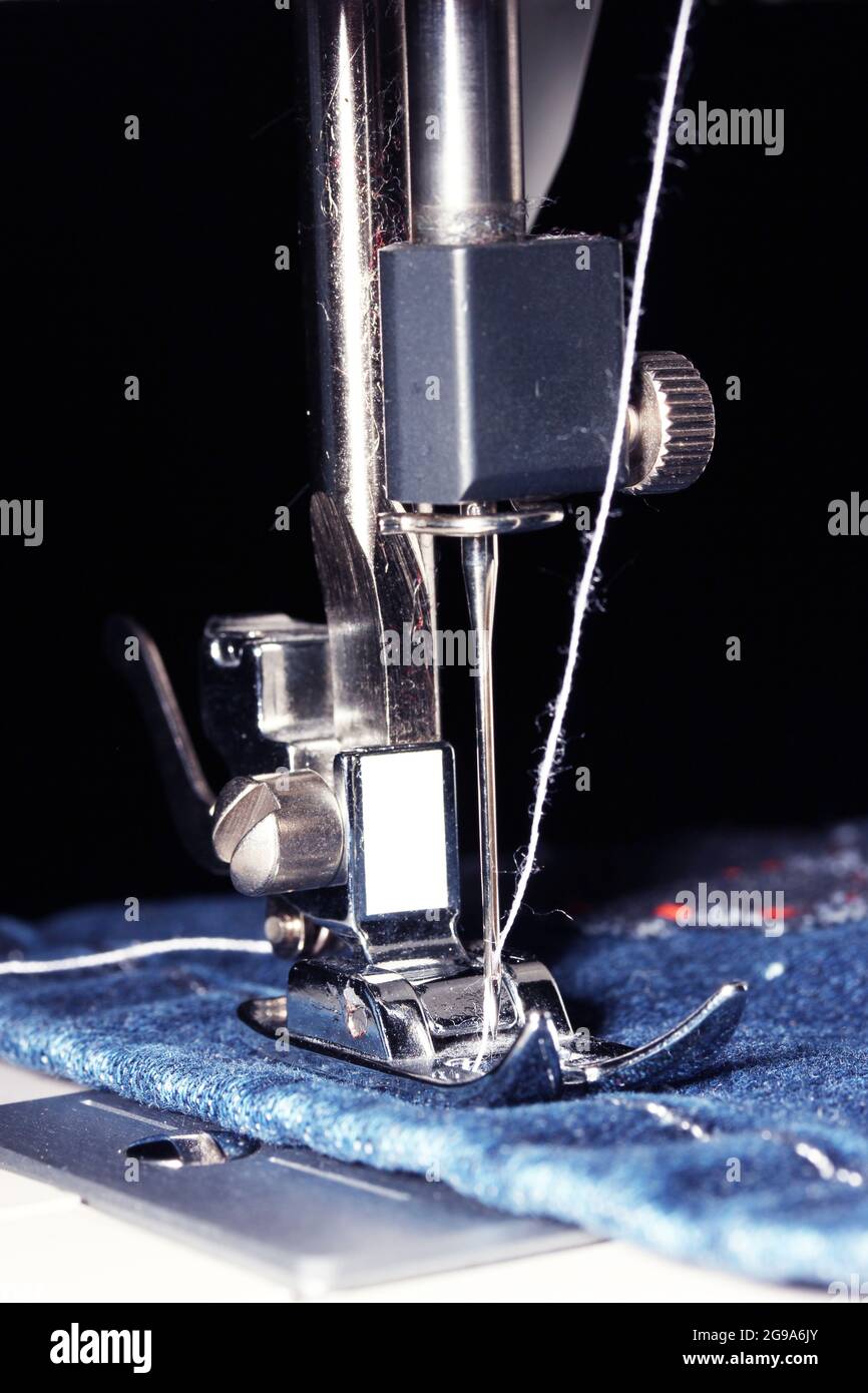 Sewing machine with jeans closeup Stock Photo - Alamy