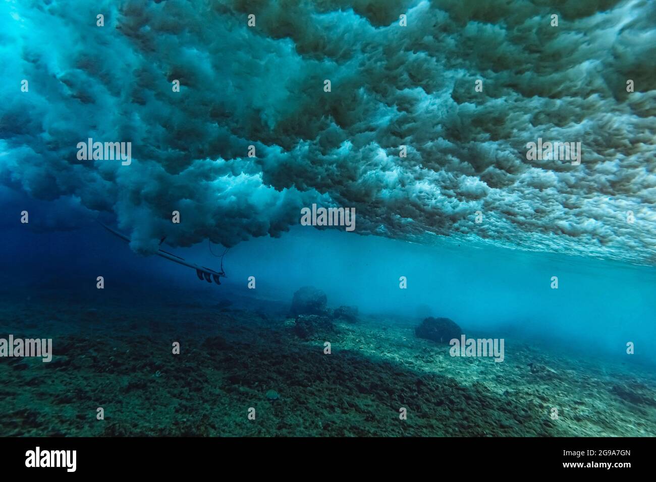Under water view of wave, surfer sitting on surfboard, underwater shot ...