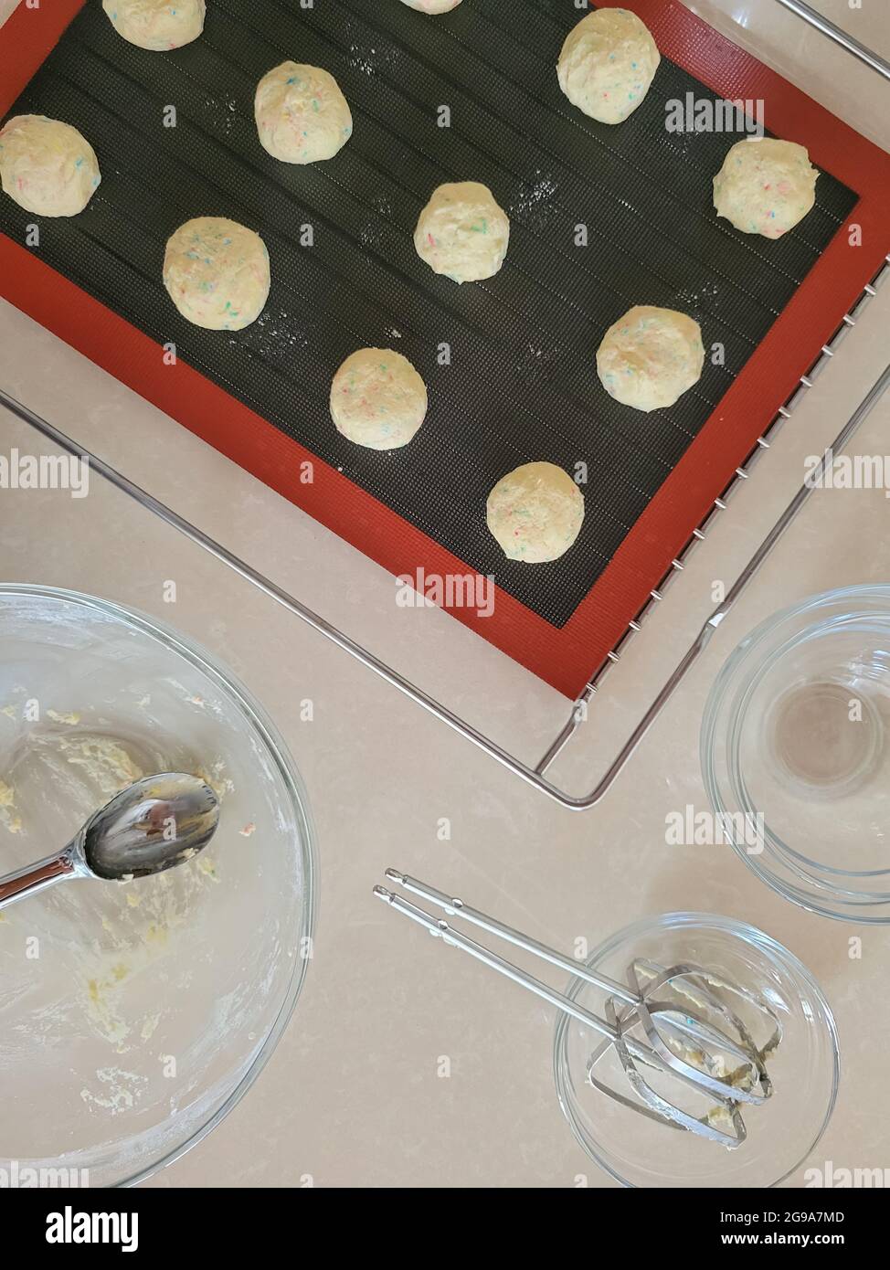 Raw cookie dough, spoon, beater whisks and glass bowls Stock Photo - Alamy