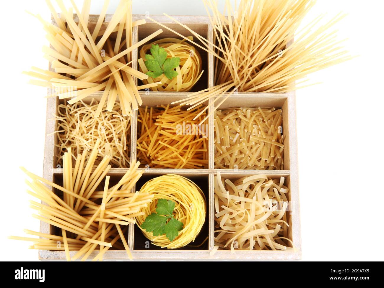 Nine types of pasta in wooden box sections isolated on white Stock ...