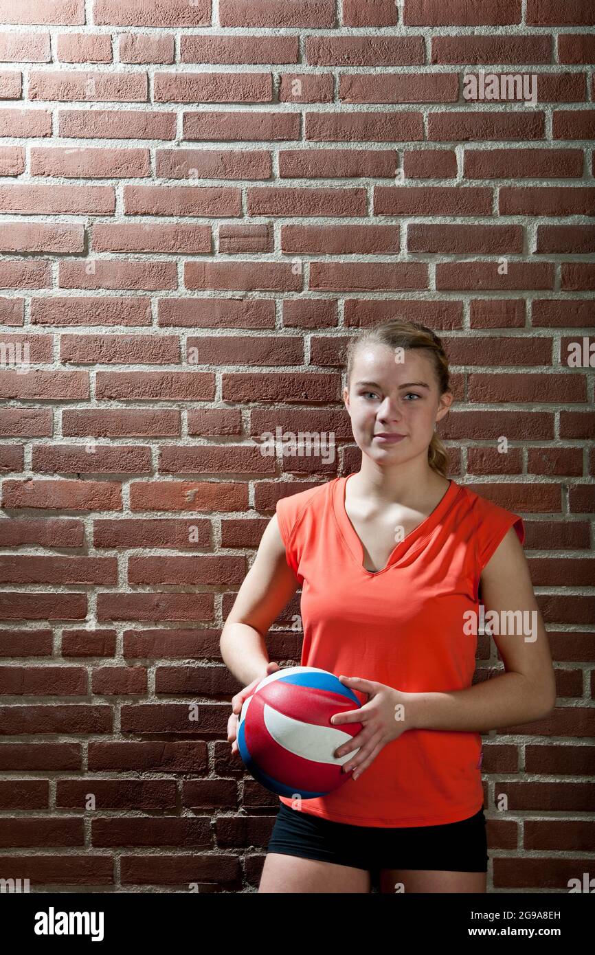portrait of volleyball player against brick wall Stock Photo - Alamy