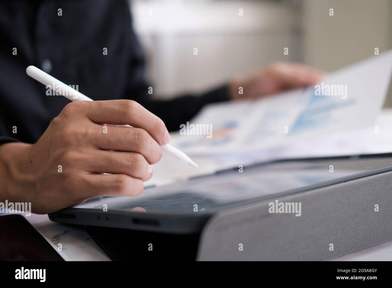 Closeup man with stylus pen writing on digital notepad, touching on ...