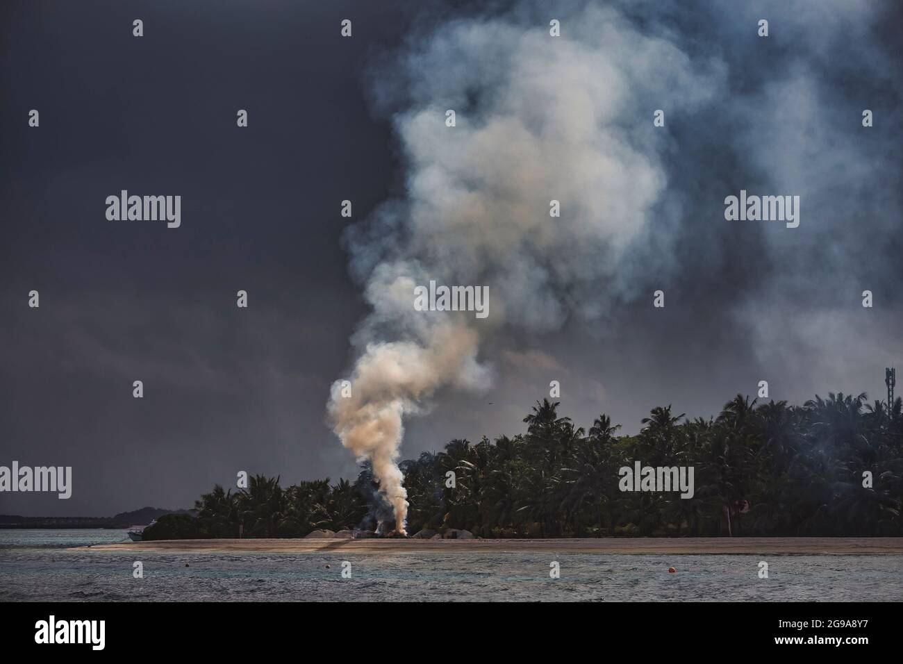 Smoke at tropical beach, Maldives Stock Photo - Alamy