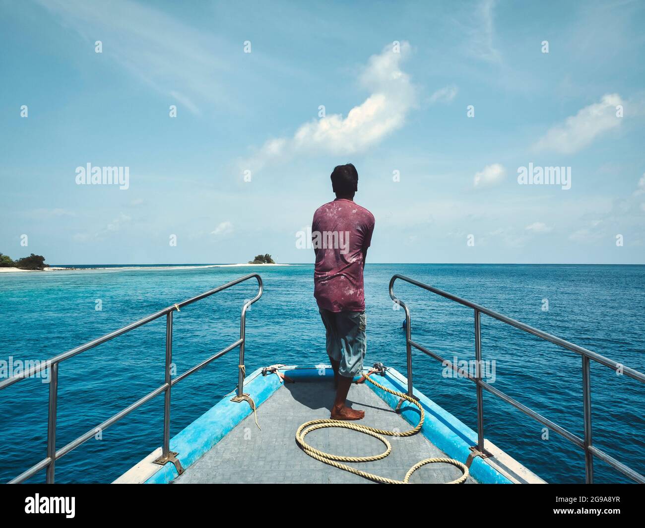 Rear view of fisherman at the boat Stock Photo - Alamy