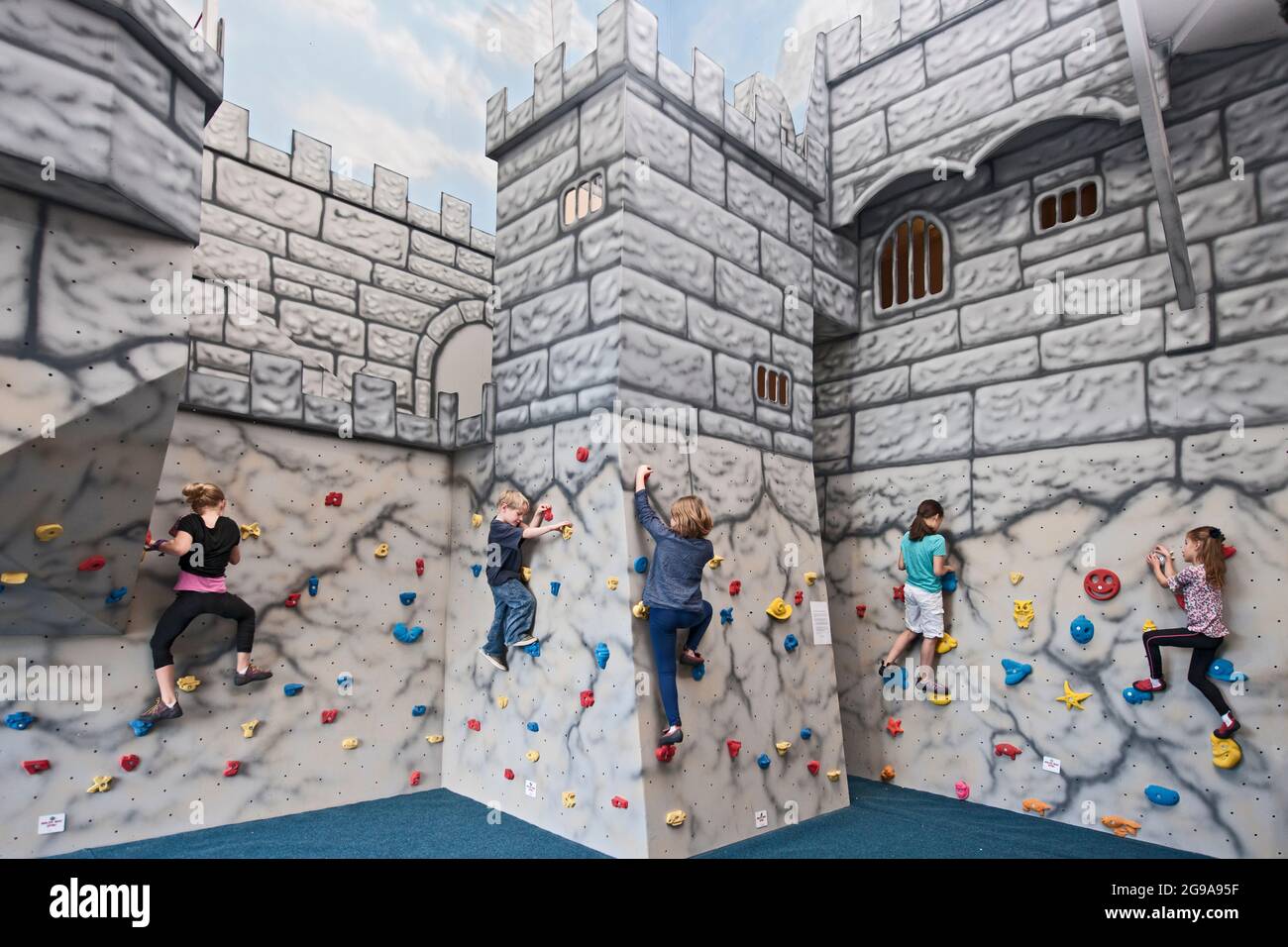children bouldering on castle like climbing wall Stock Photo - Alamy