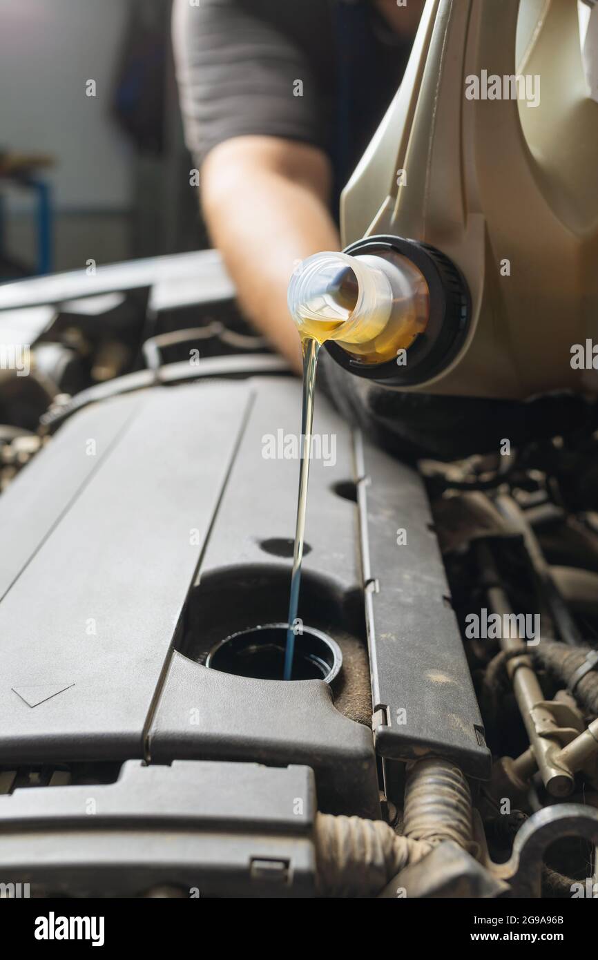 Mechanic pouring oil car hi-res stock photography and images - Alamy