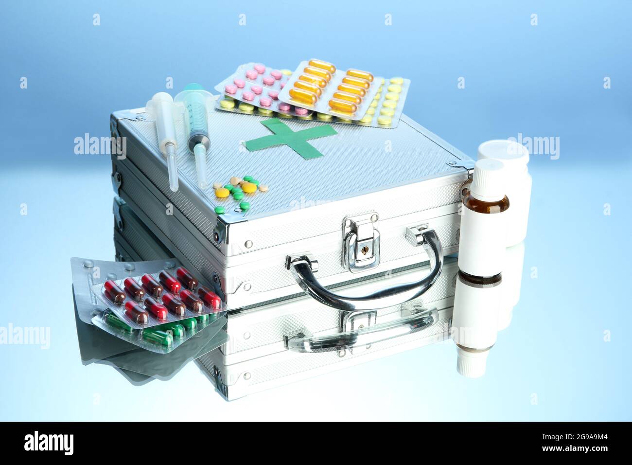 First aid box, on blue background Stock Photo - Alamy