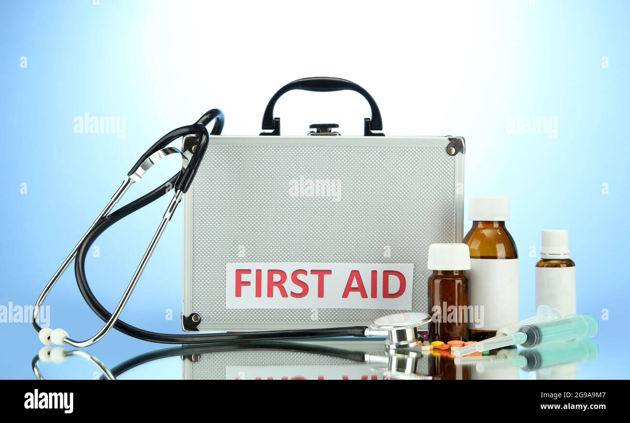 First aid box, on blue background Stock Photo - Alamy