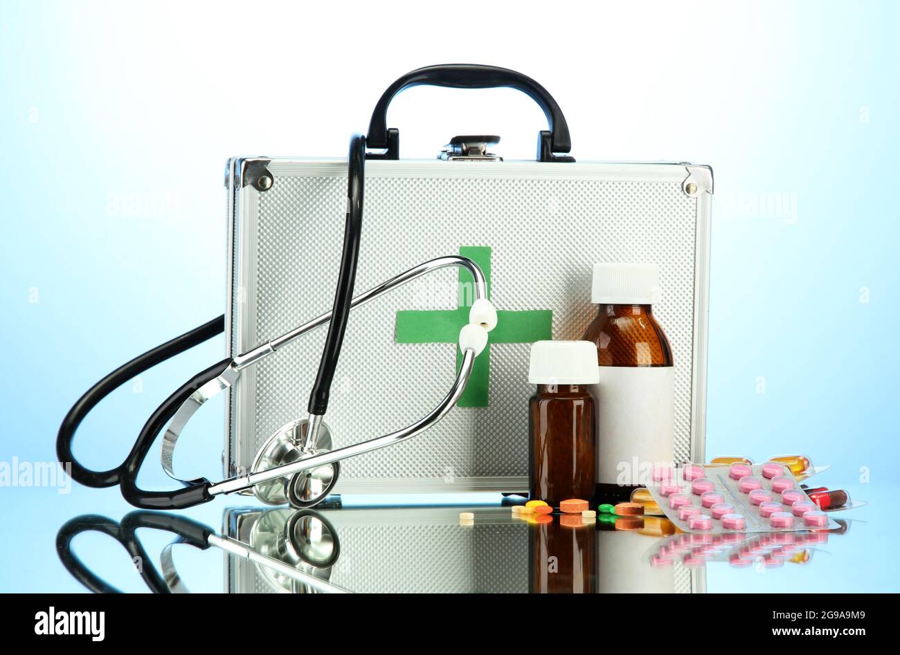 First aid box, on blue background Stock Photo - Alamy