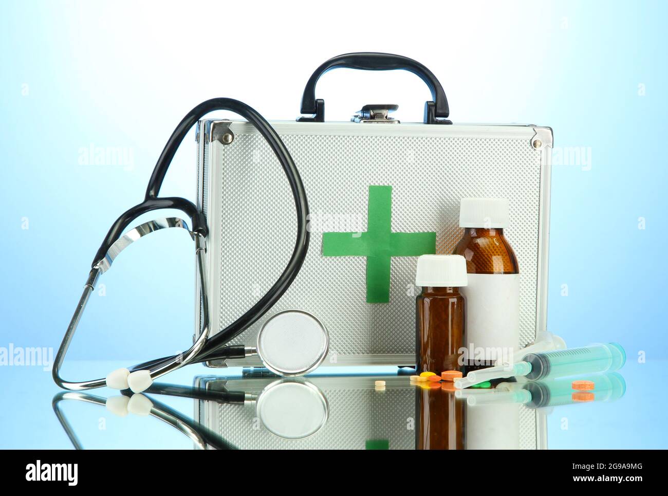 First aid box, on blue background Stock Photo - Alamy