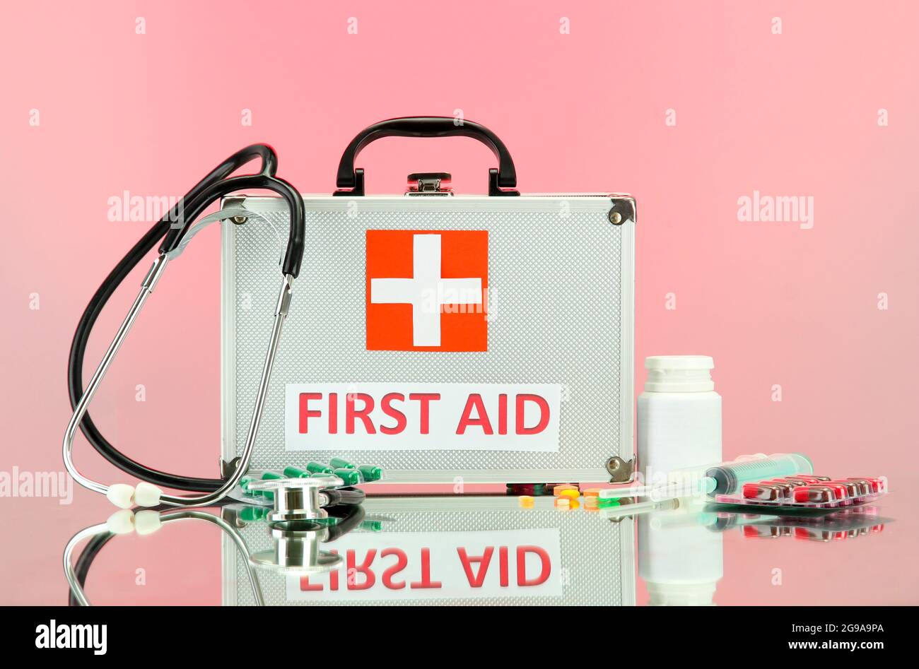 First aid box, on pink background Stock Photo - Alamy
