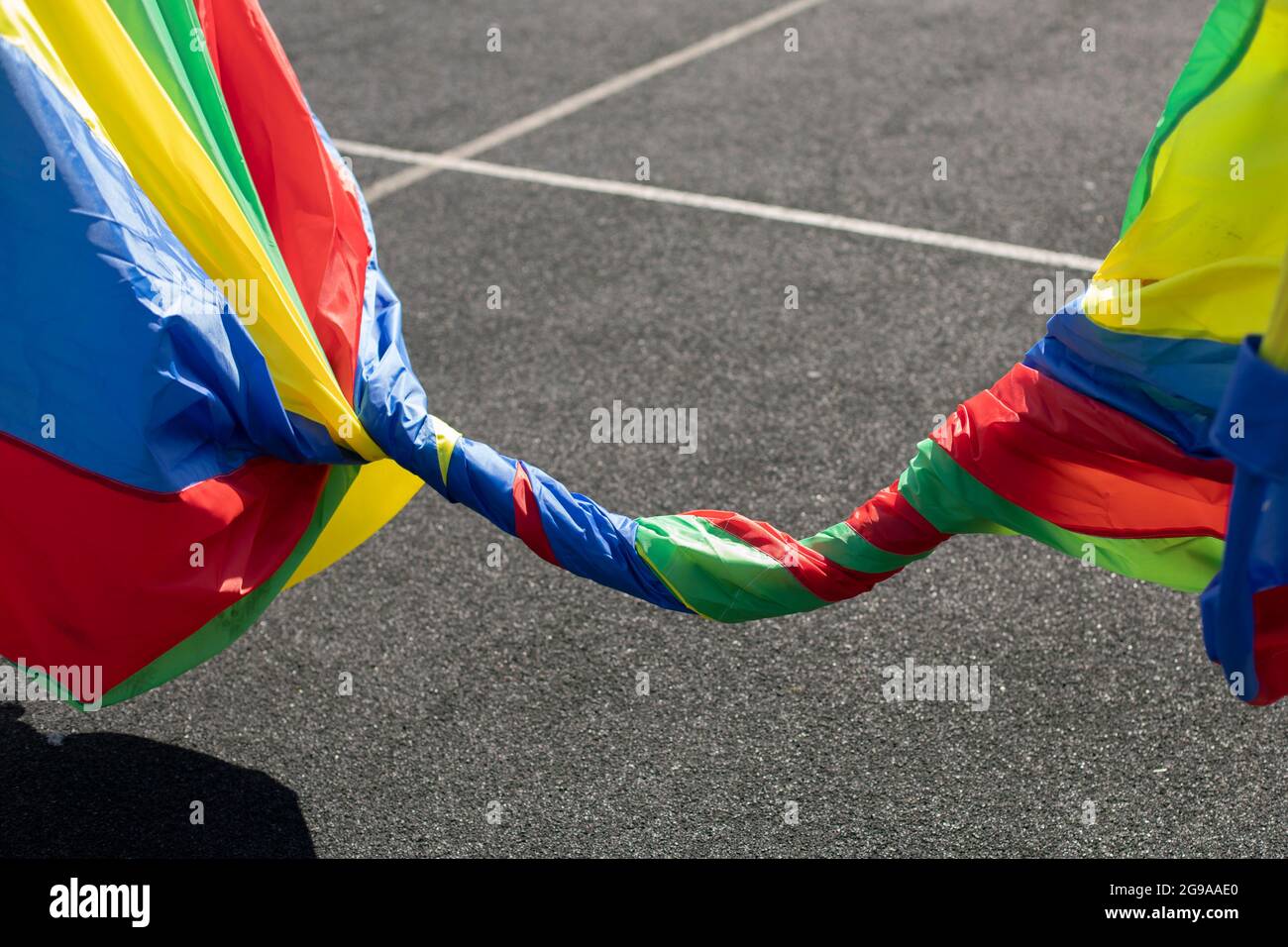 Twisting the fabric of different colors. Colored matter on the street ...